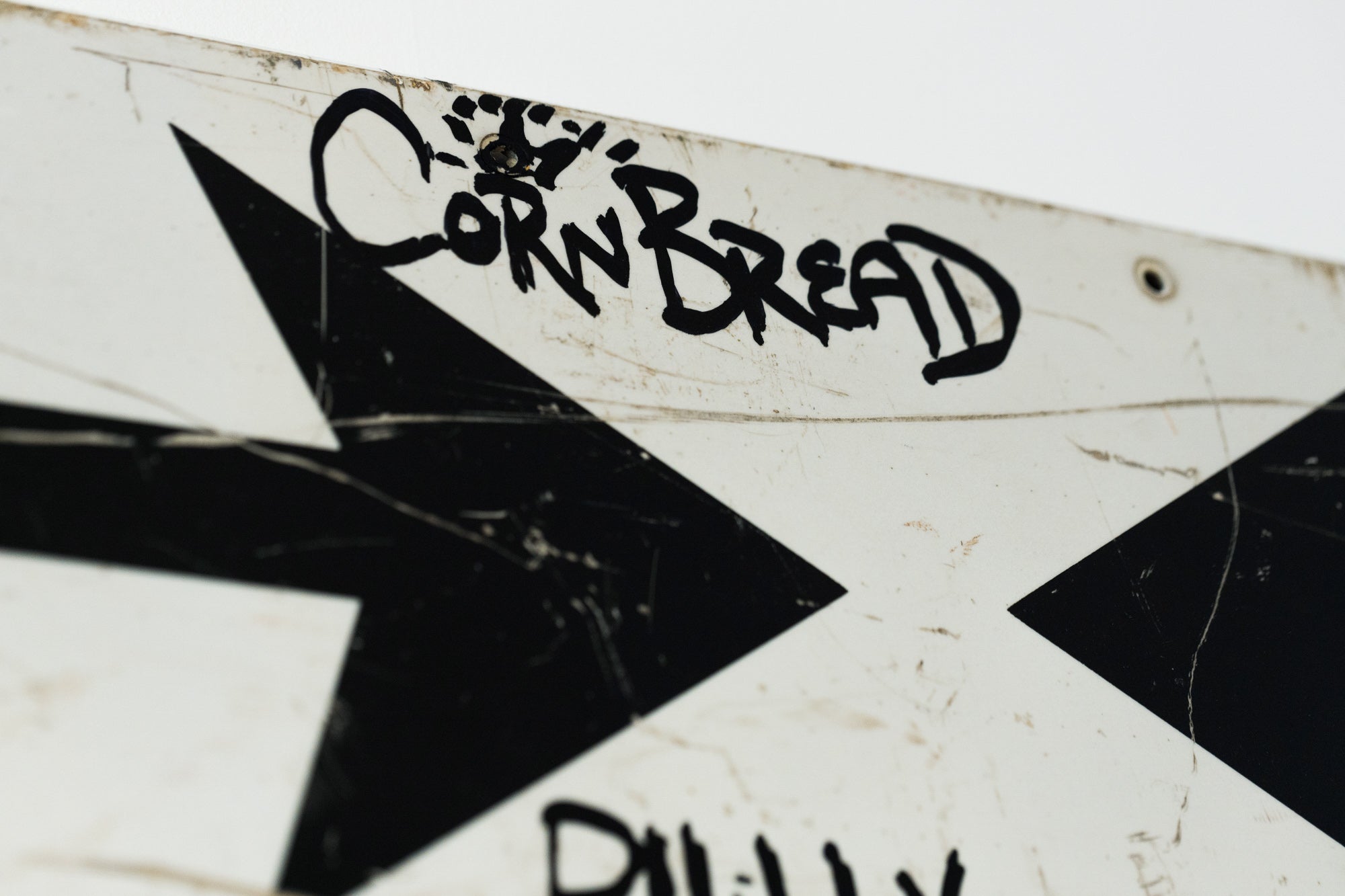 Cornbread Philly Sign (black arrows) – Paradigm Gallery + Studio