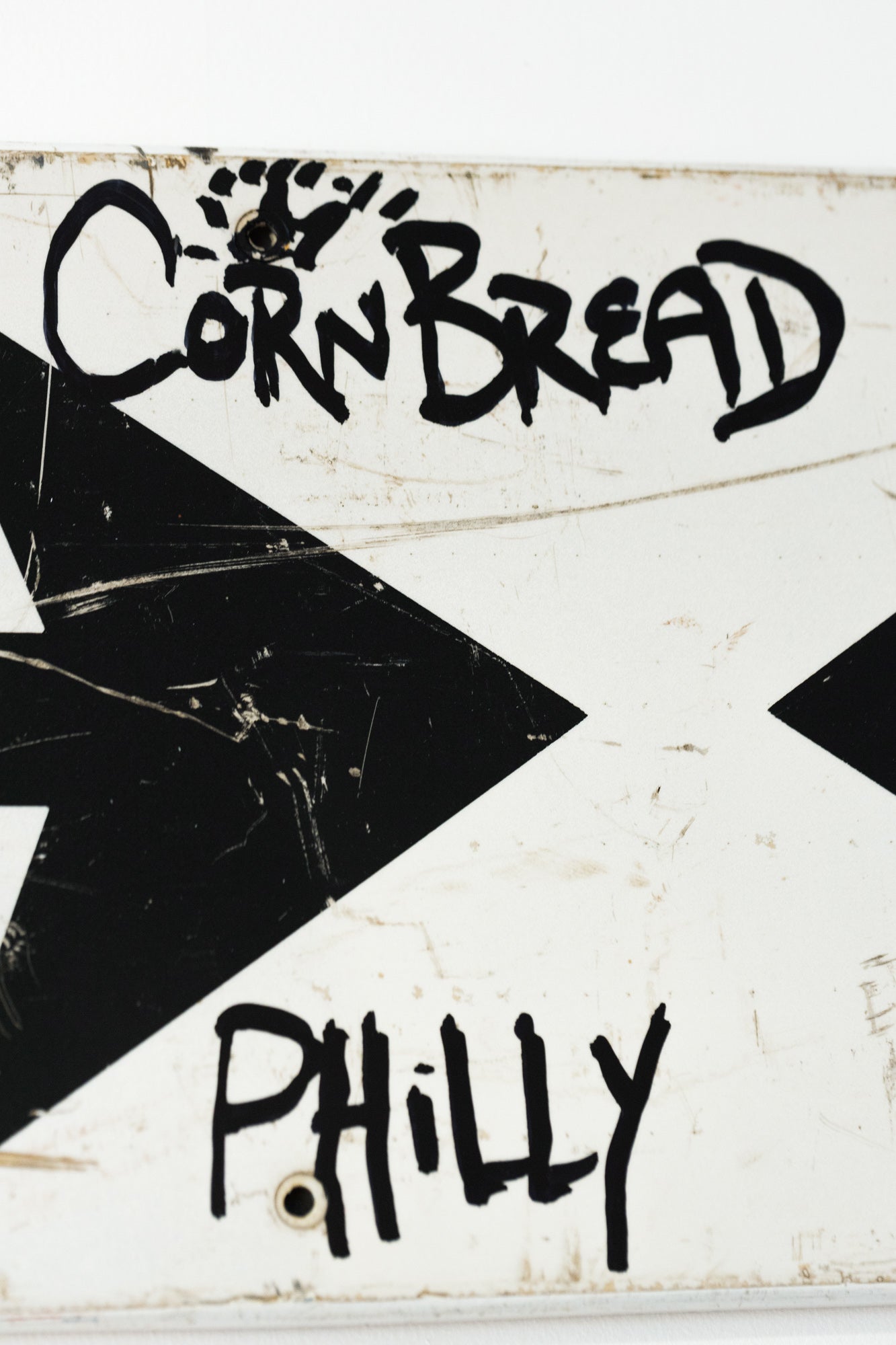 Cornbread Philly Sign (black arrows) – Paradigm Gallery + Studio